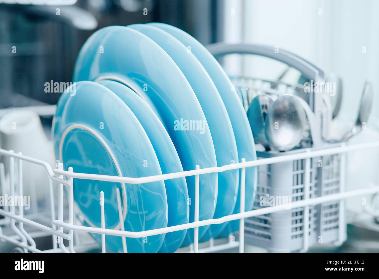 Clean dishes in dishwasher close-up, background is blurred Stock Photo ...