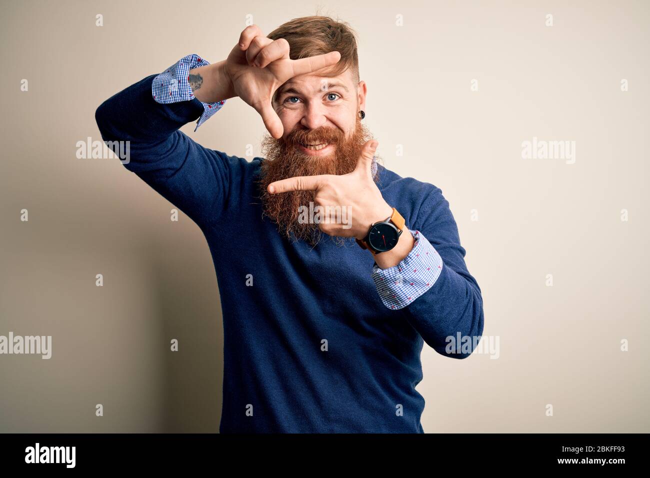 Handsome Irish redhead business man with beard standing over isolated ...