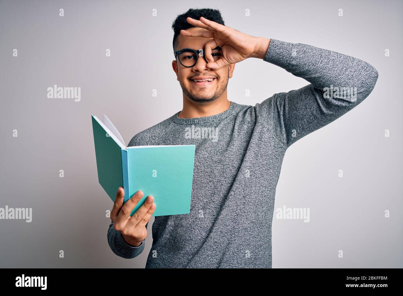 Young handsome smart student man reading book over isolated white ...