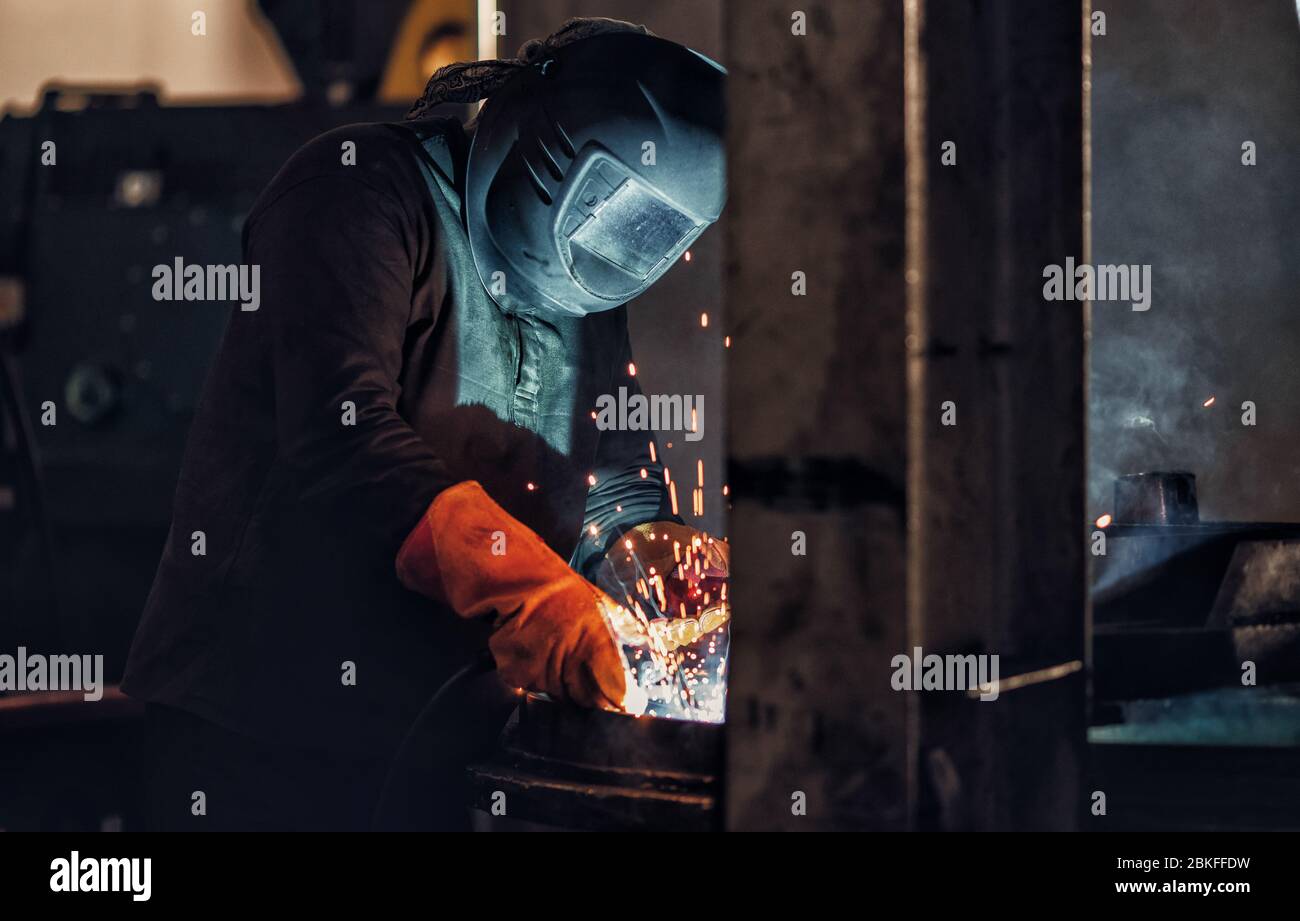 Professional welder performs welding hi-res stock photography and ...