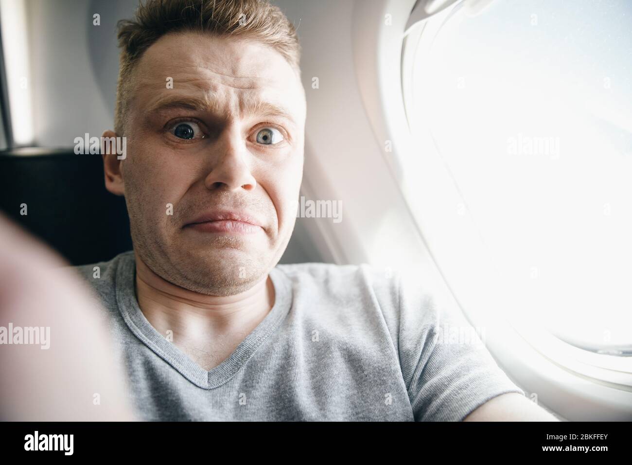 Scared passenger on plane hi-res stock photography and images - Alamy
