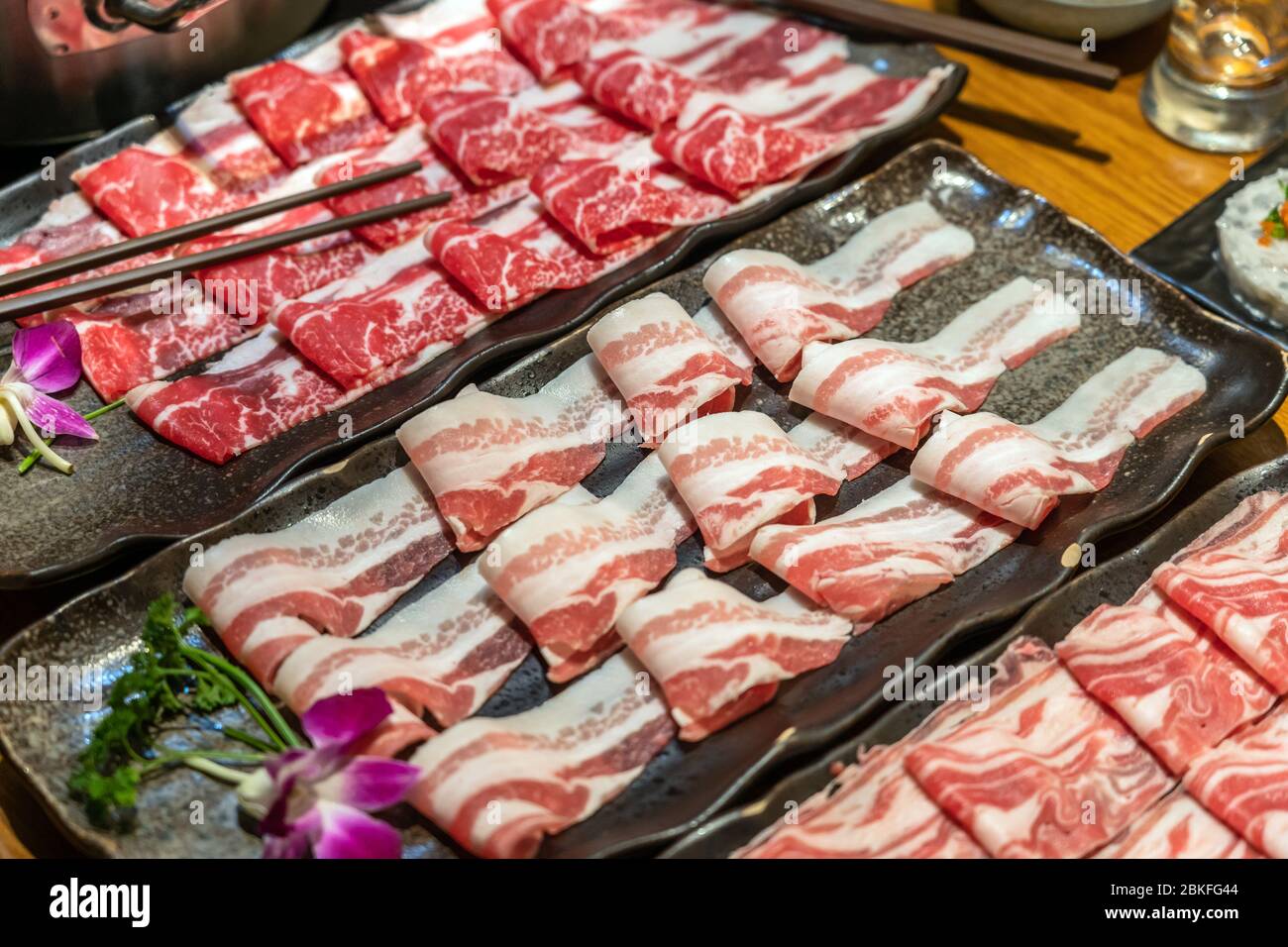Selection of meat platters to be cooked in hotpot restaurant, including ...