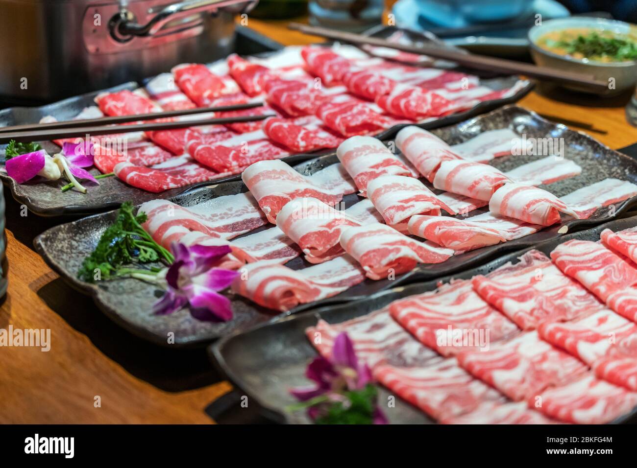 Selection of meat platters to be cooked in hotpot restaurant, including ...