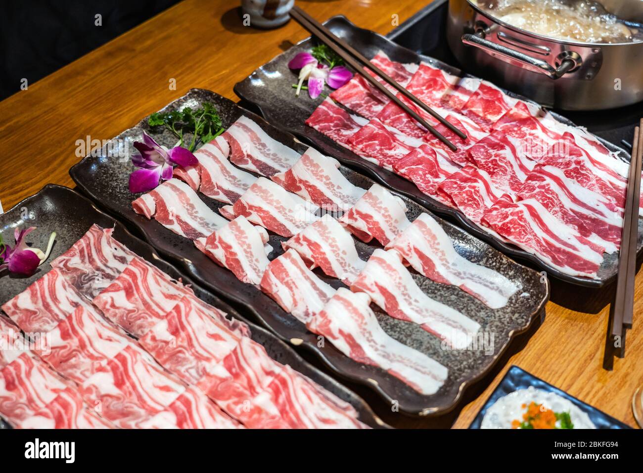 Selection of meat platters to be cooked in hotpot restaurant, including ...