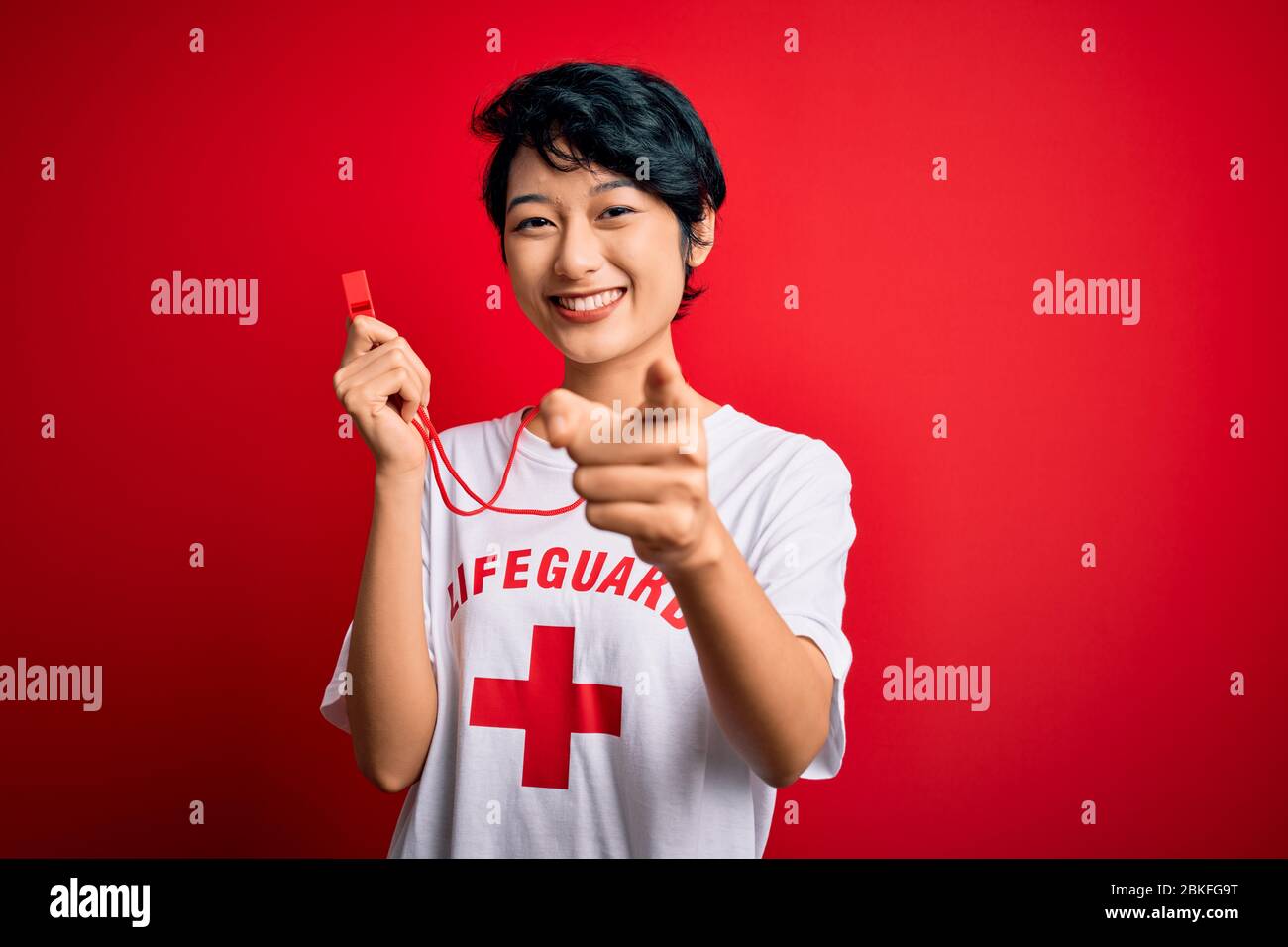 Young beautiful asian lifeguard girl wearing t-shirt with red cross ...