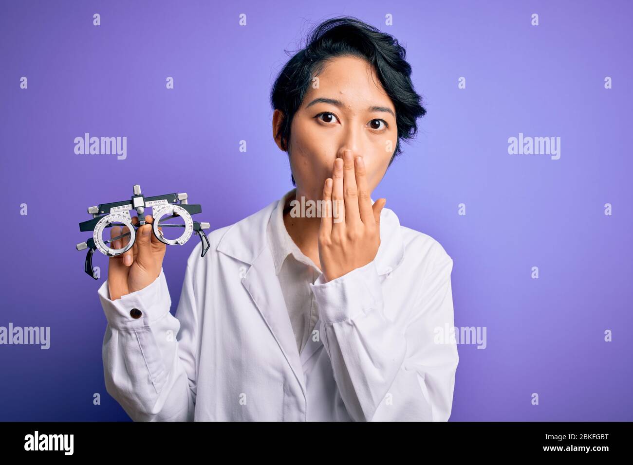 Beautiful asian optical girl wearing coat holding optometry glasses ...