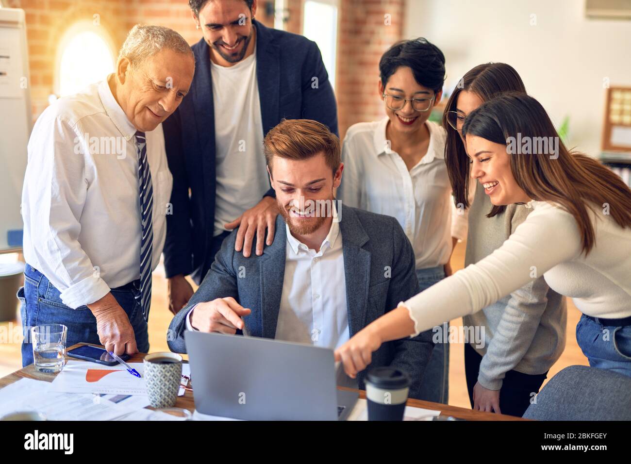 Group of business workers smiling happy and confident. One of them ...