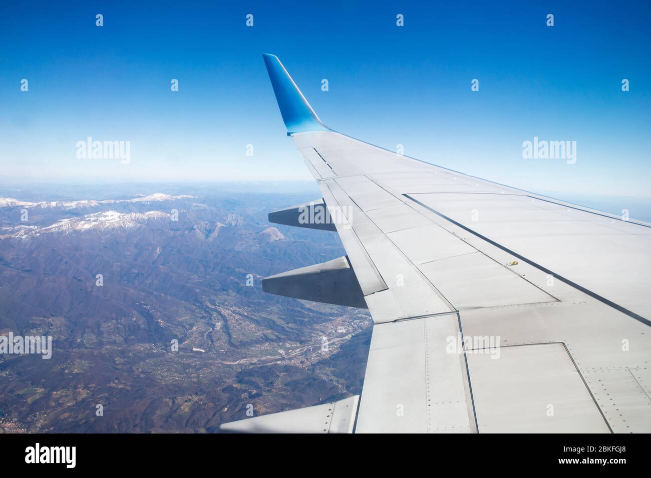 Wing of an airplane flying over alps hi-res stock photography and ...