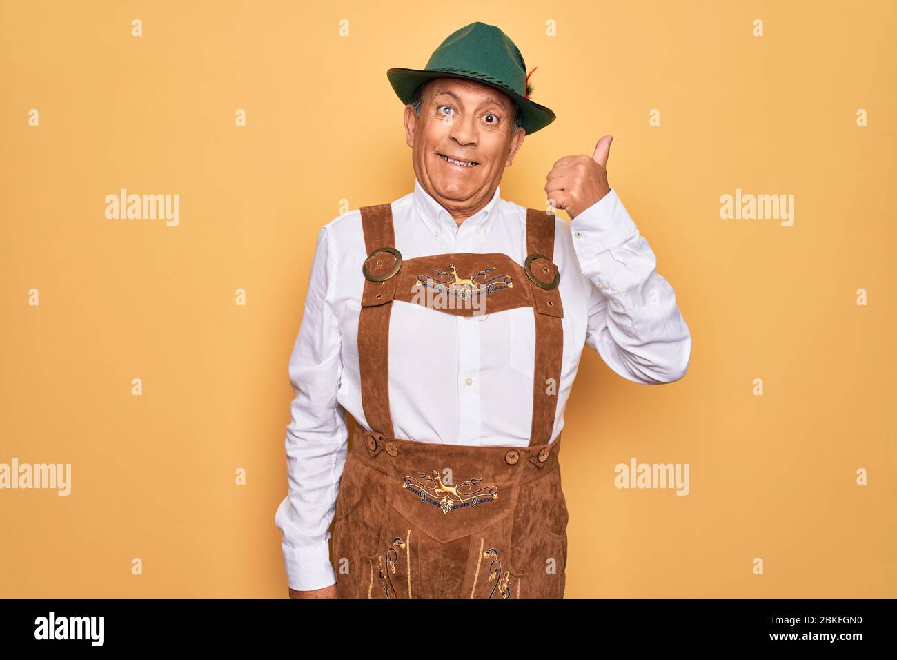 Senior grey-haired man wearing german traditional octoberfest suit over ...