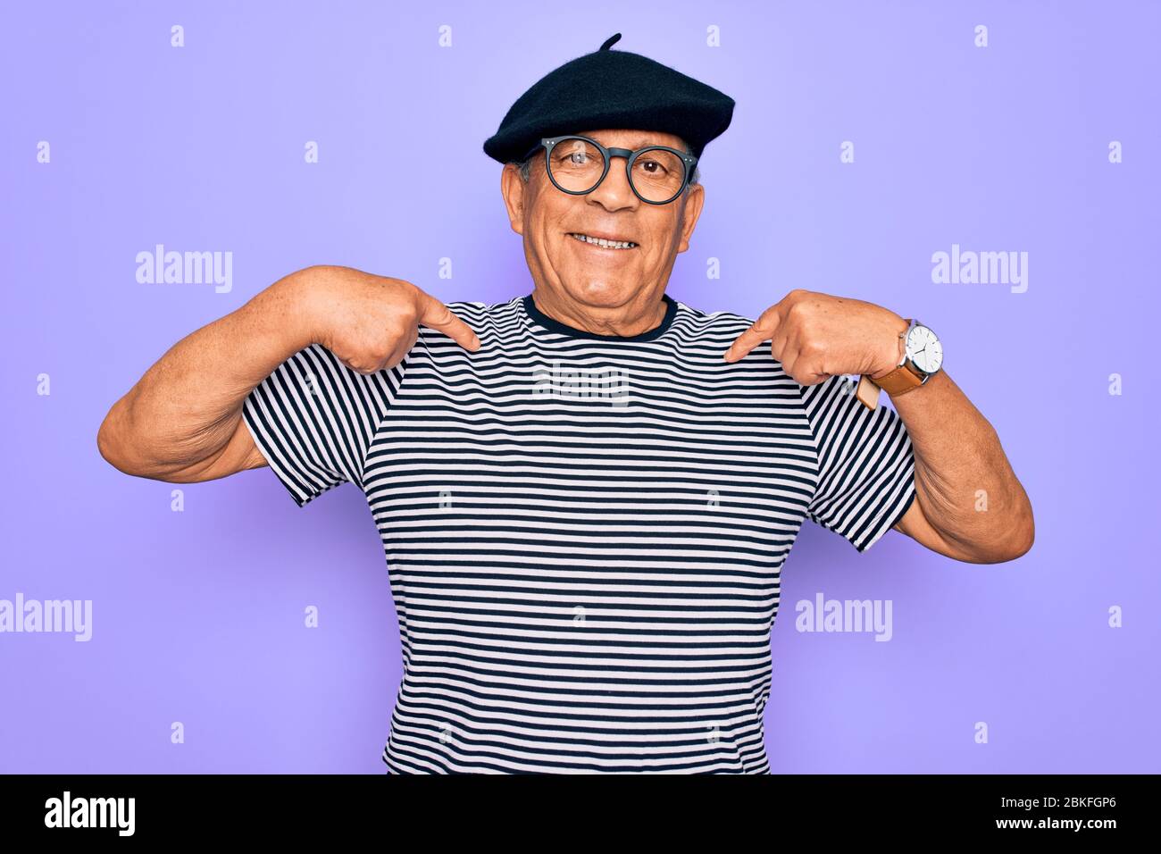 Senior handsome hoary man wearing french beret and glasses standing ...