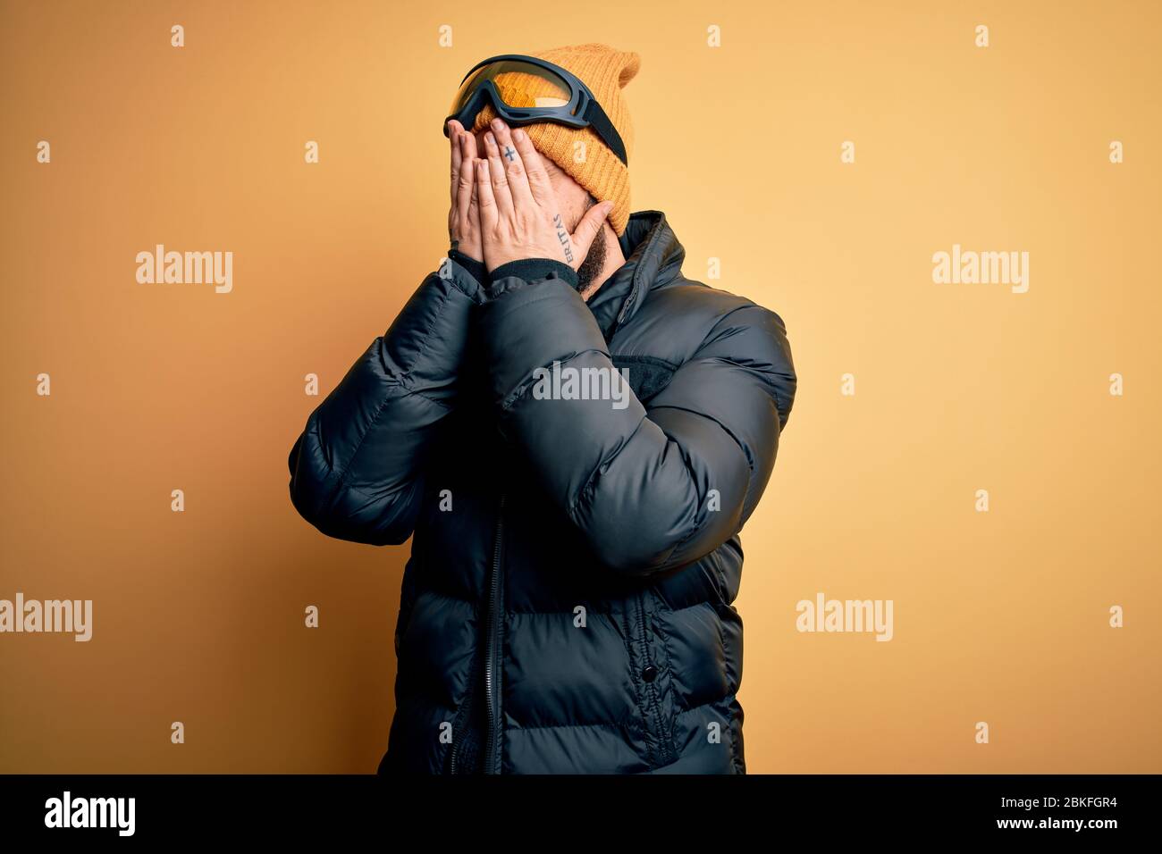 Handsome skier bald man with beard skiing wearing snow sportswear and ...