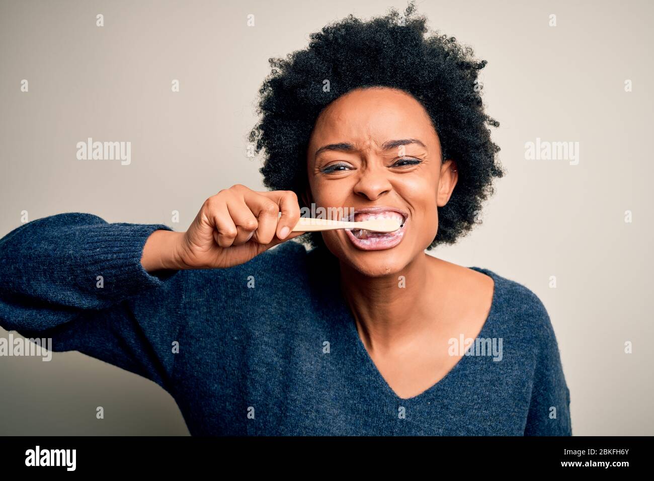 African american woman brushing her teeth using tooth brush and oral ...