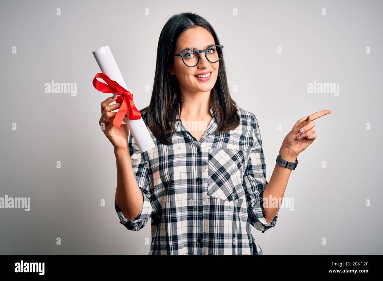 Young brunette student woman with blue eyes holding university diploma ...