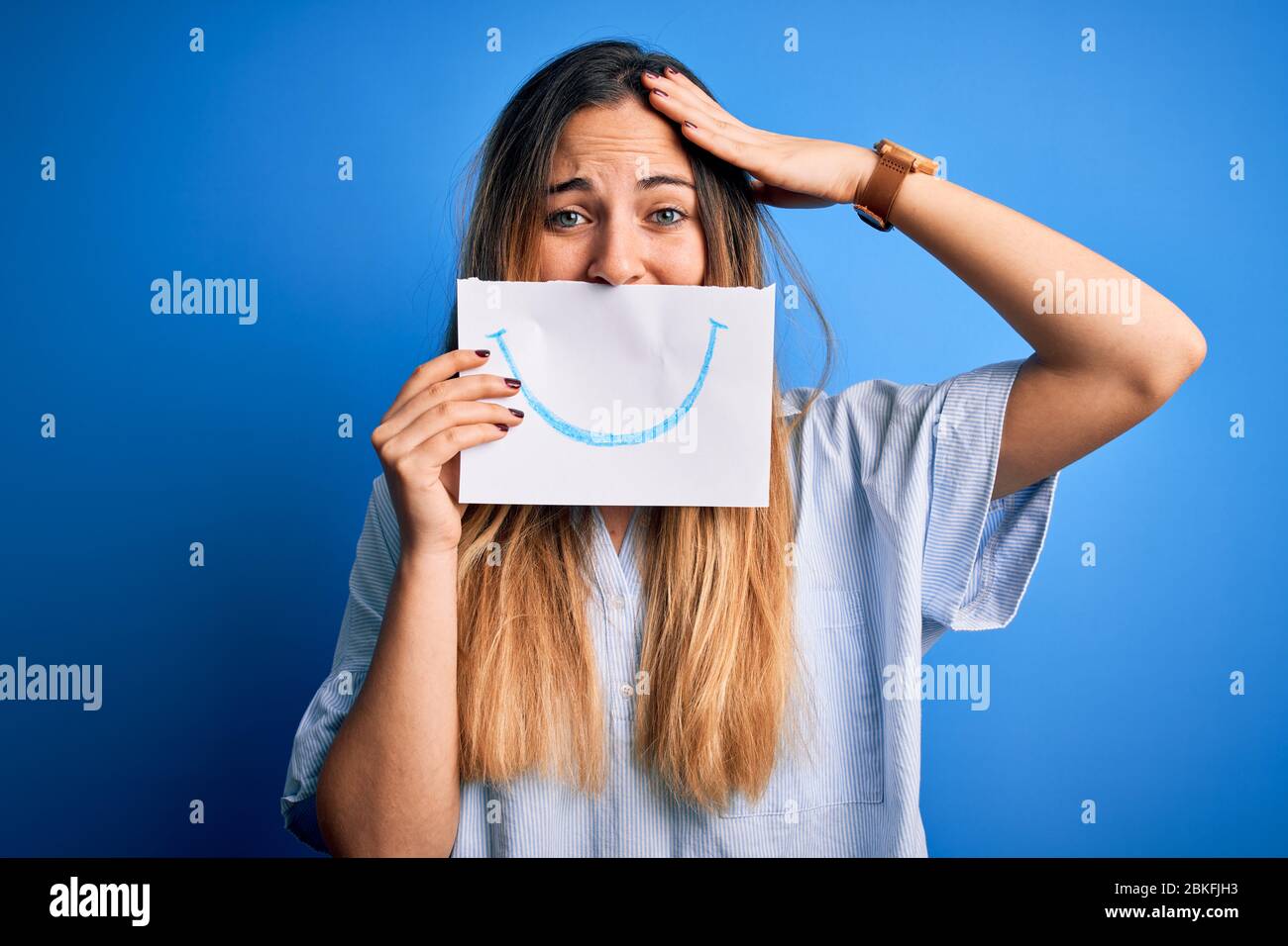 Young beautiful brunette woman holding card with smile illustration on ...