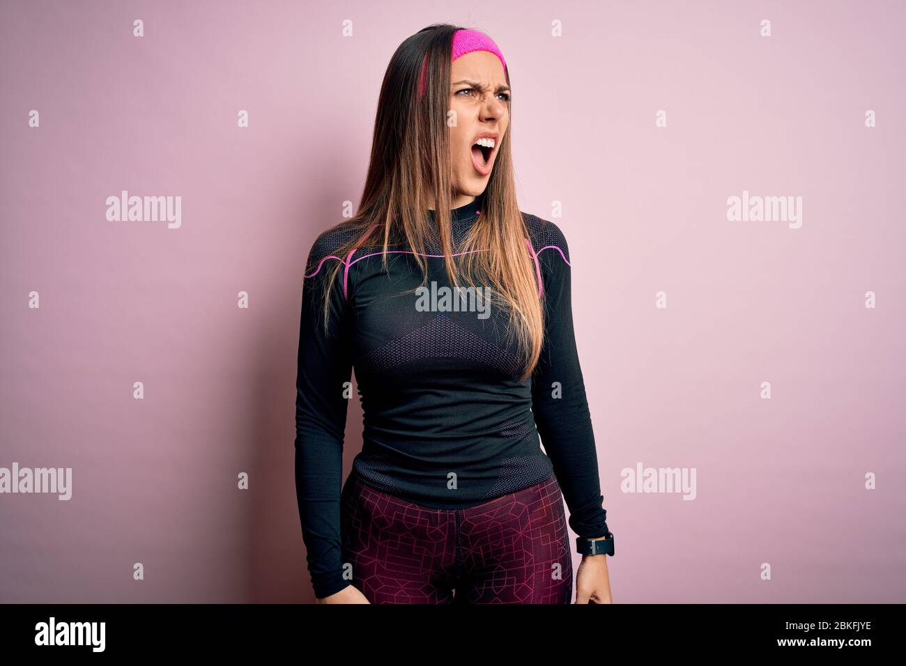 Young blonde fitness woman wearing sport workout clothes over isolated ...