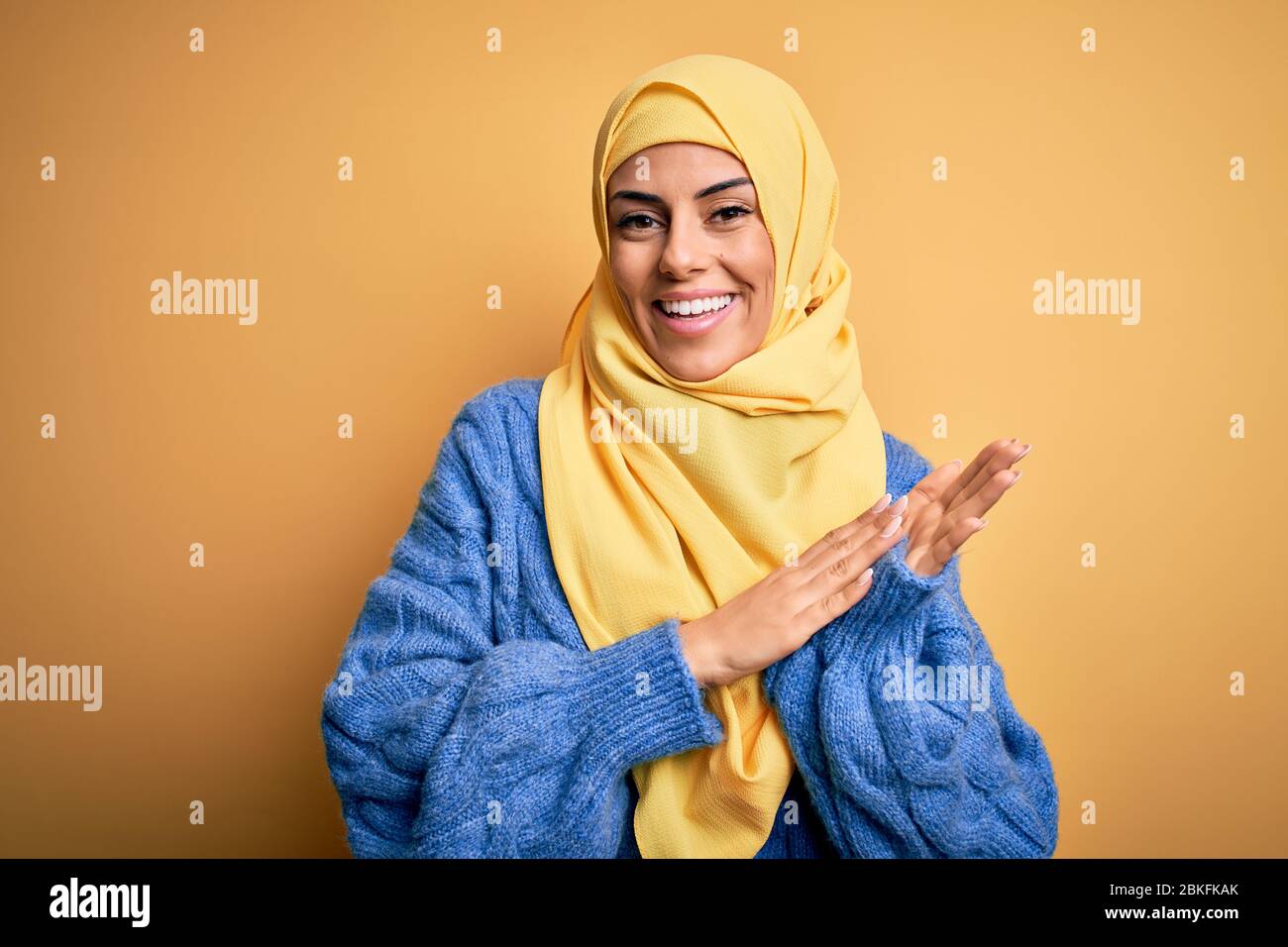 Young beautiful brunette muslim woman wearing arab hijab over isolated ...