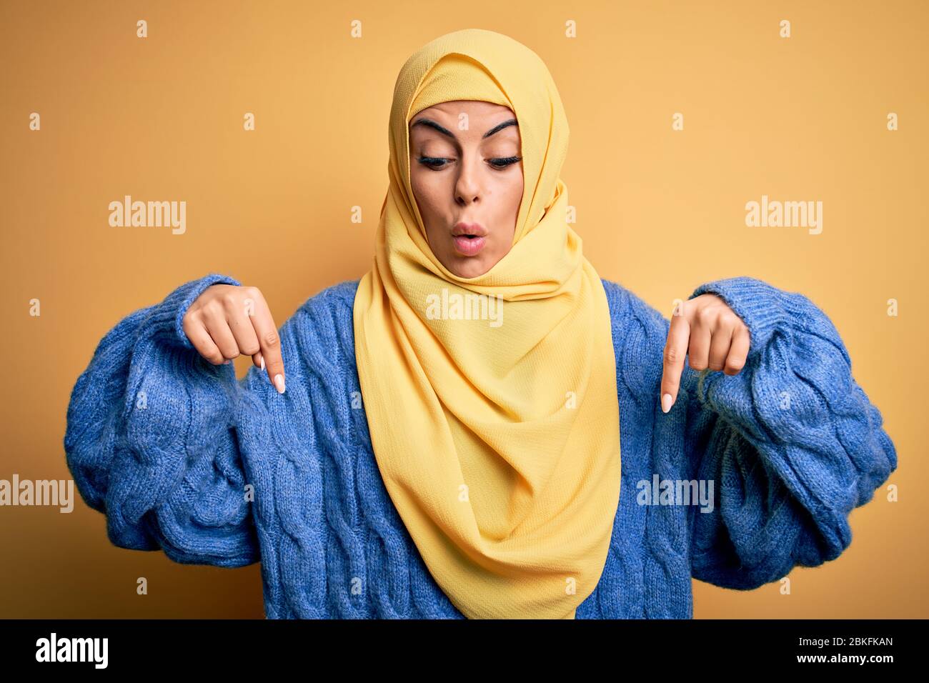 Young beautiful brunette muslim woman wearing arab hijab over isolated ...