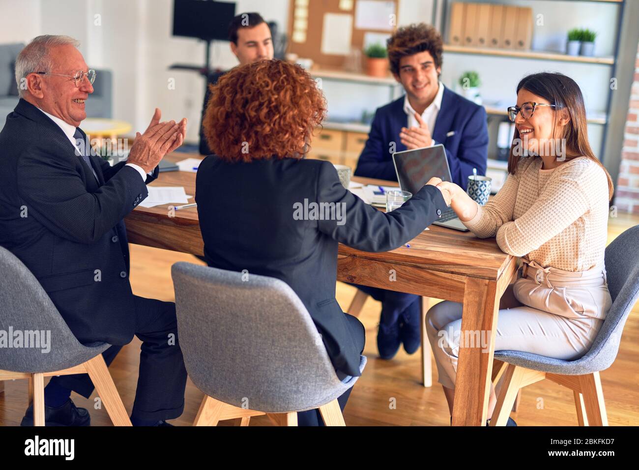 Group of business workers smiling happy and confident in a meeting ...