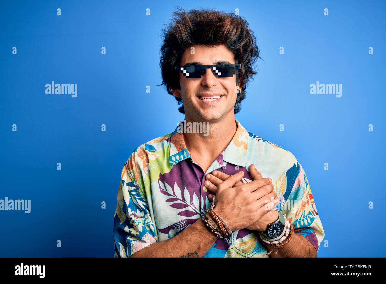 Young handsome man wearing thug life glasses standing over isolated ...