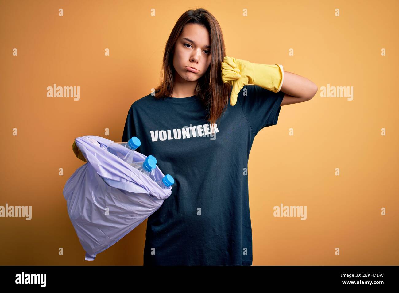Beautiful volunteer girl caring environment doing volunteering holding ...