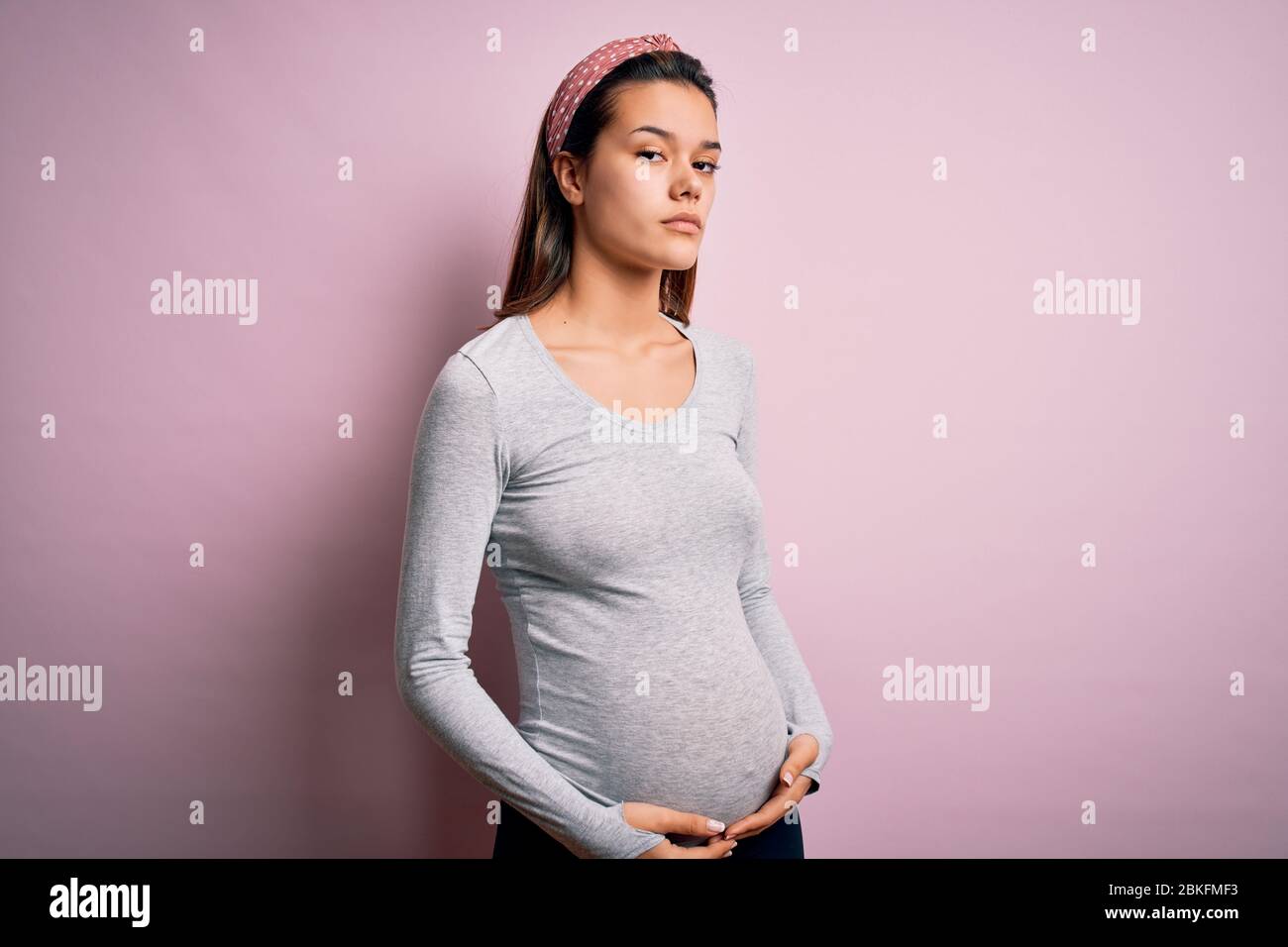 Young beautiful teenager girl pregnant expecting baby over isolated ...