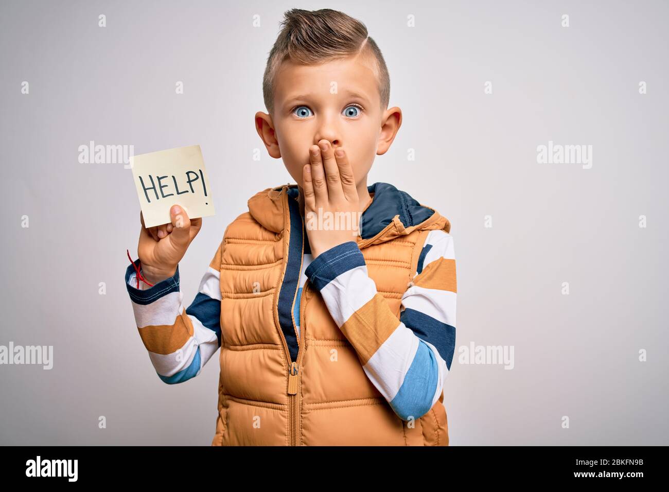 Young little caucasian kid asking for help on a paper note as violence ...