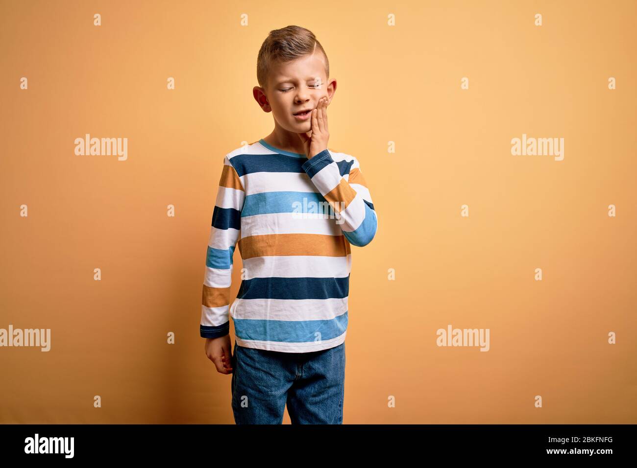Young little caucasian kid with blue eyes wearing colorful striped ...