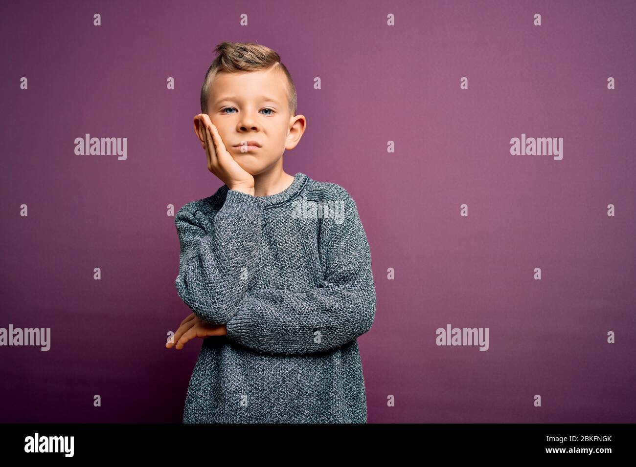 Young little caucasian kid with blue eyes wearing winter sweater ...