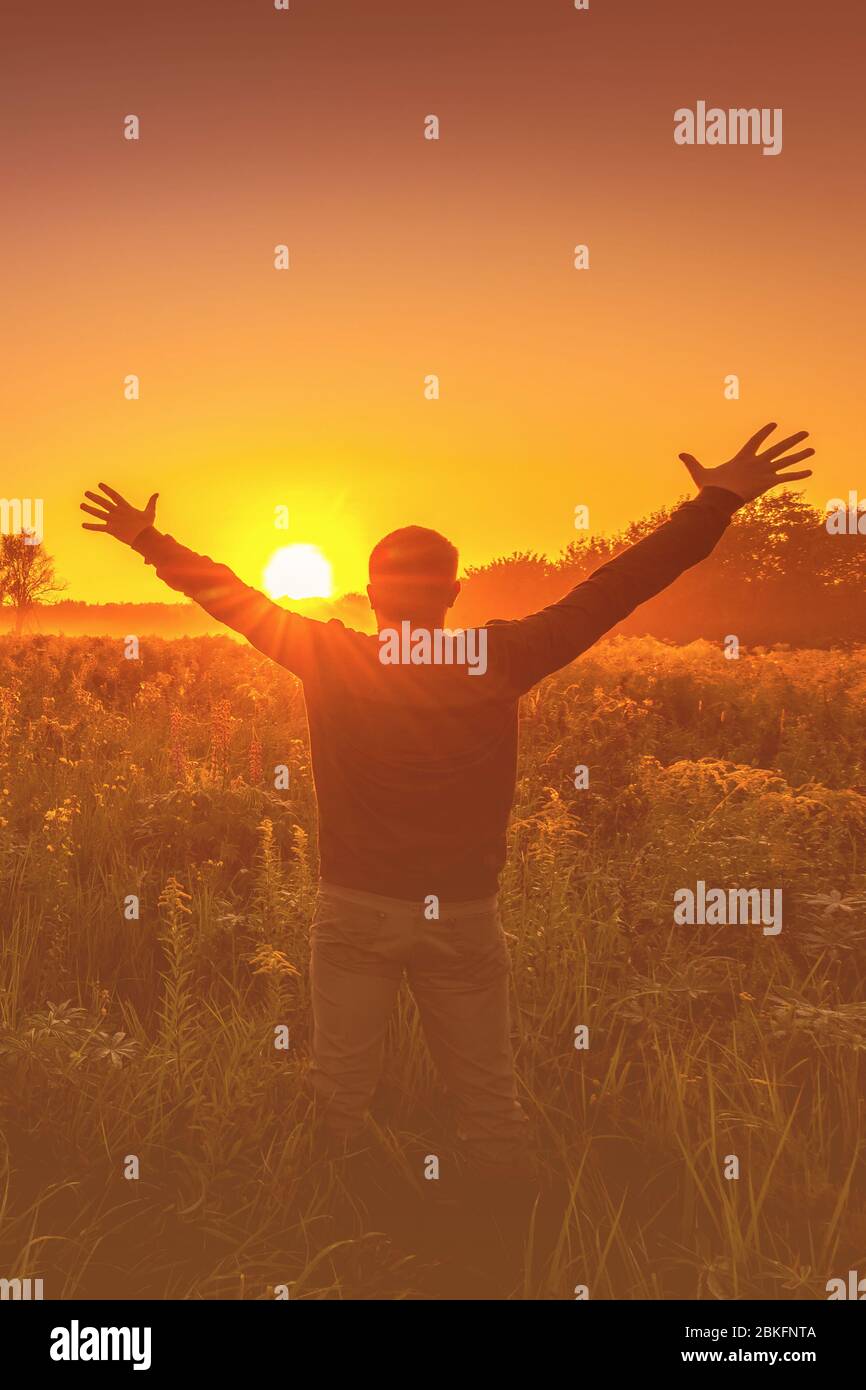 Happy man silhouette with arms raised in success on sunrise hi-res ...