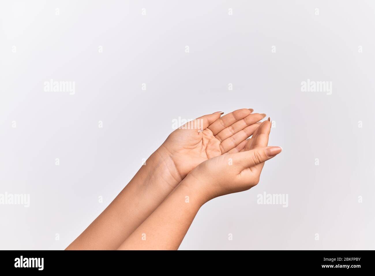 Hand of caucasian young woman asking and offering with both hands ...