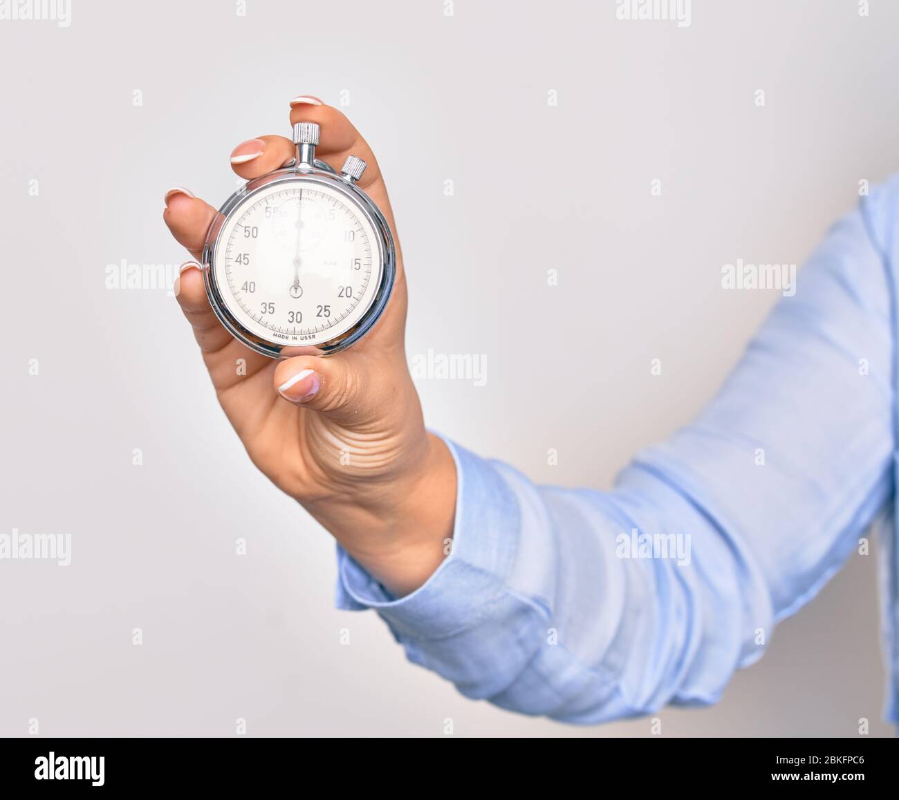 Hand of caucasian young woman counting time using stopwatch over ...