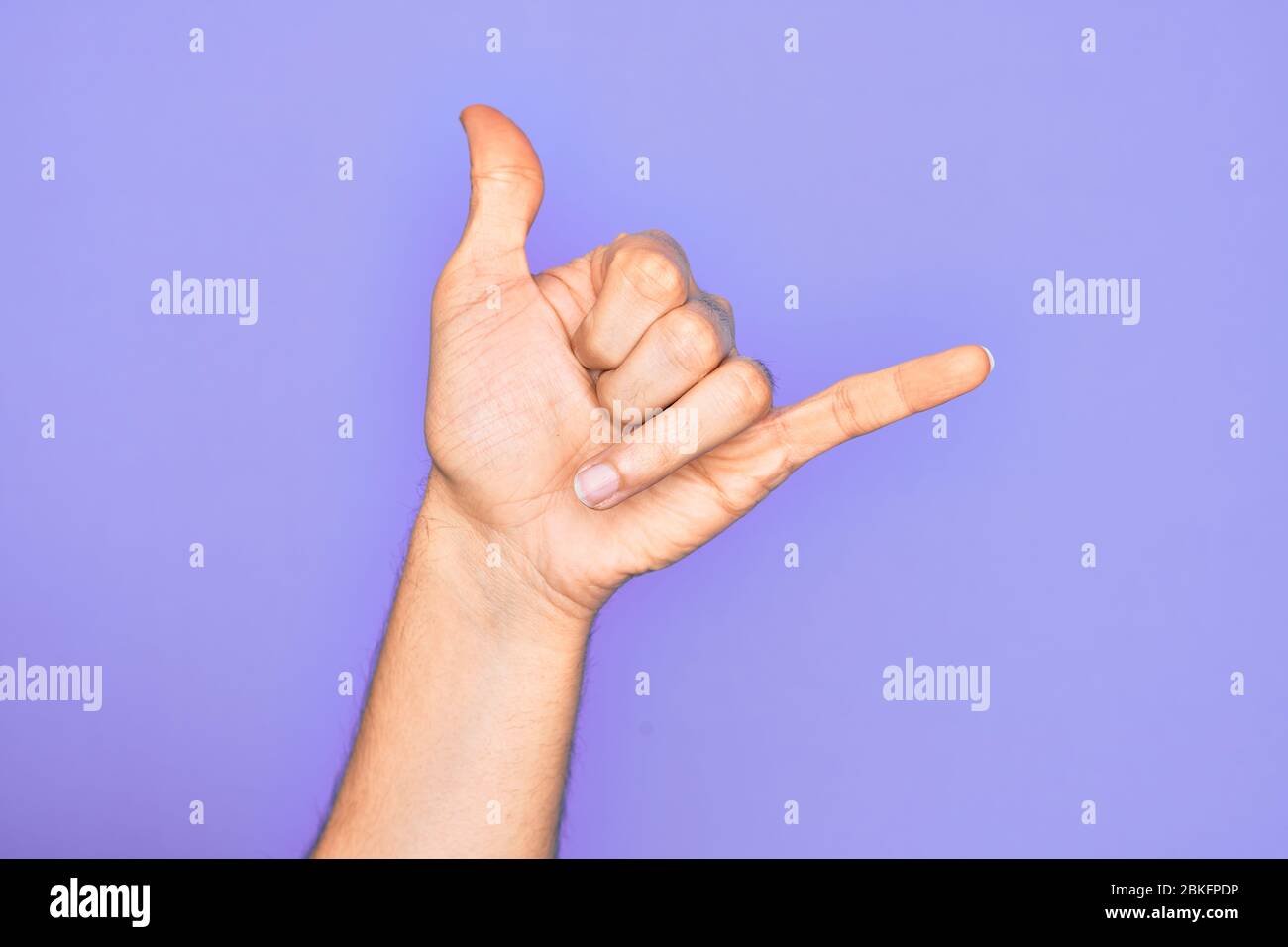 Hand of caucasian young man showing fingers over isolated purple ...