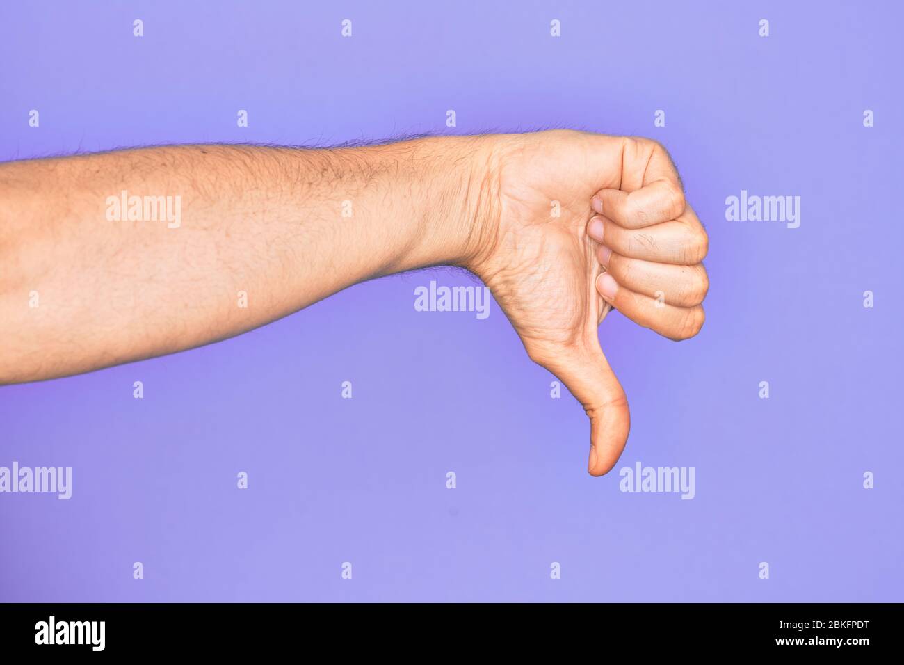 Hand of caucasian young man showing fingers over isolated purple ...