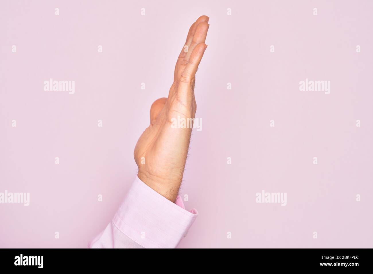 Hand of caucasian young man showing fingers over isolated pink ...