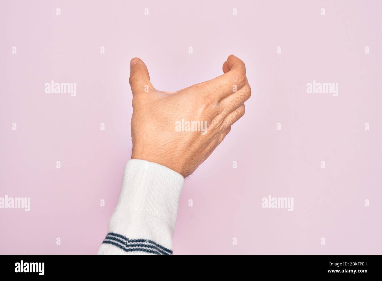 Hand of caucasian young man showing fingers over isolated pink ...