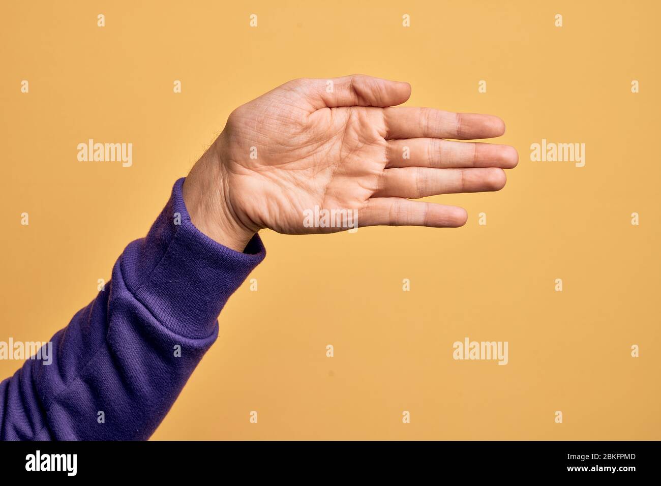 Hand of caucasian young man showing fingers over isolated yellow ...