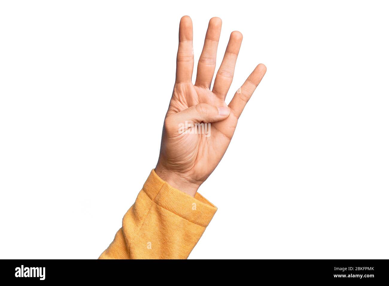 Hand of caucasian young man showing fingers over isolated white background counting number 4 ...