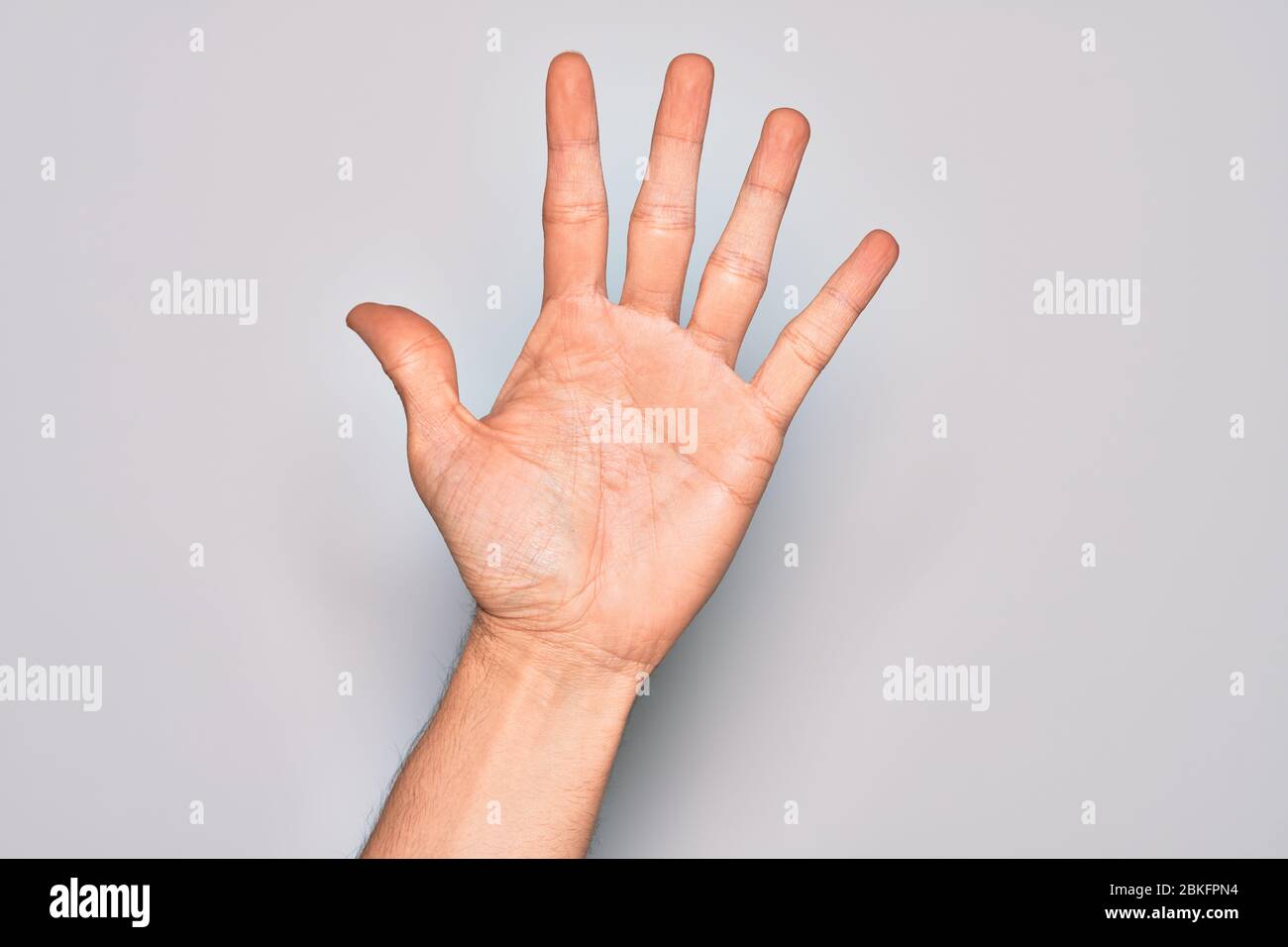 Hand of caucasian young man showing fingers over isolated white ...