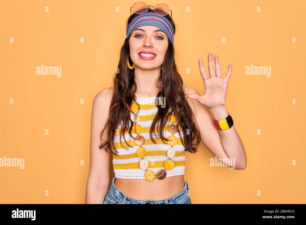 Young beautiful hippie woman with blue eyes wearing accesories and ...