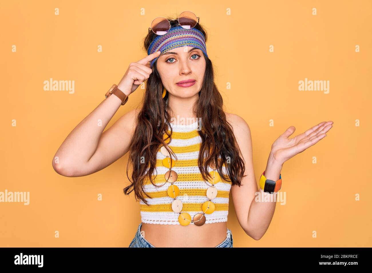 Young beautiful hippie woman with blue eyes wearing accesories and ...
