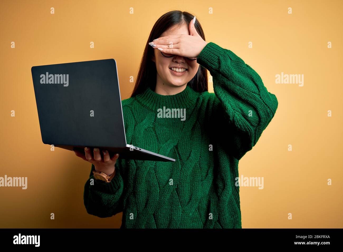 Young asian business woman wearing glasses and working using computer ...