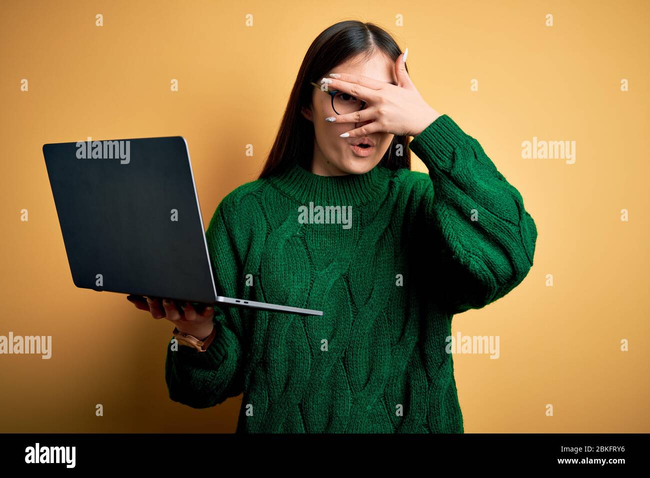 Young asian business woman wearing glasses and working using computer ...