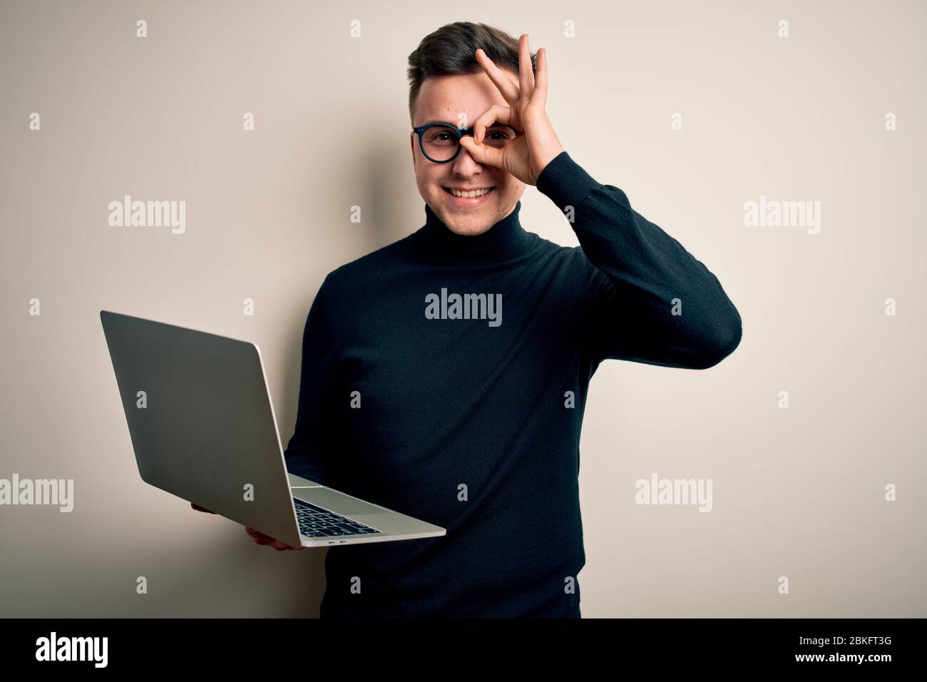 Young handsome caucasian business man wearing glasses using computer ...