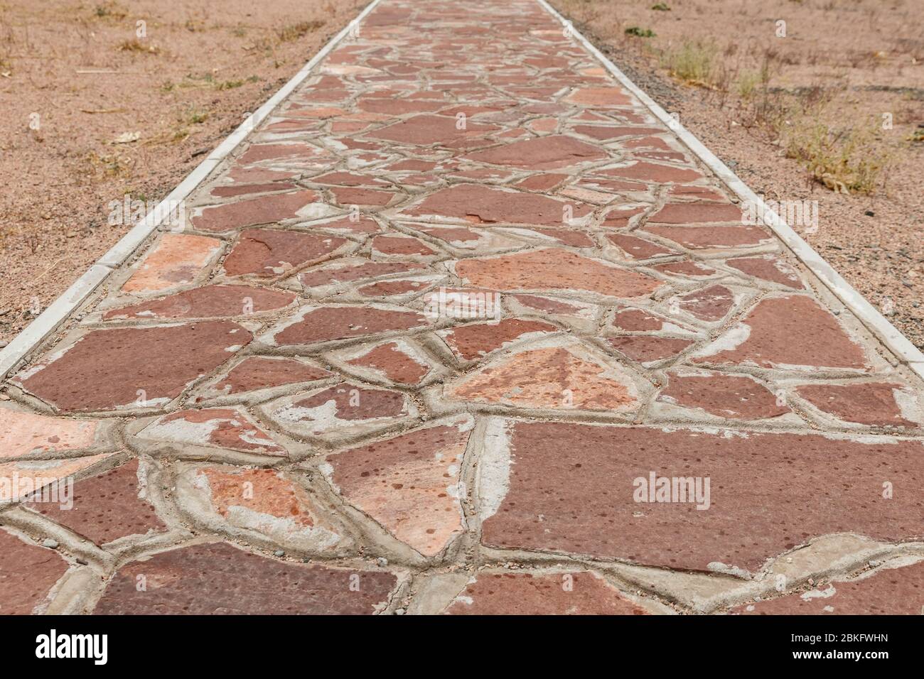 Stone walkway, Akyrtas Palace Complex in Kazakhstan. The path of red ...
