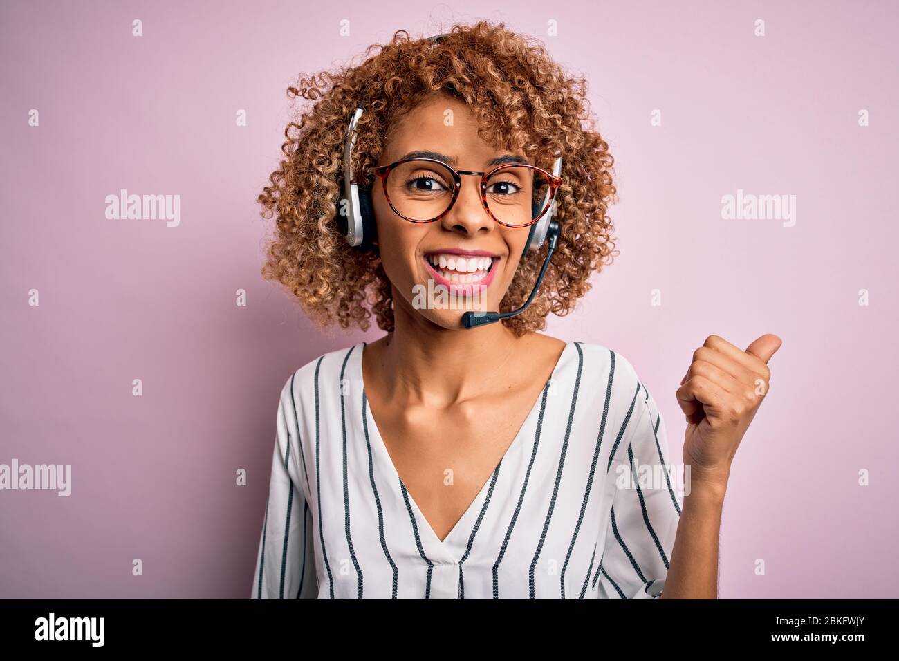 African american curly call center agent woman working using headset ...