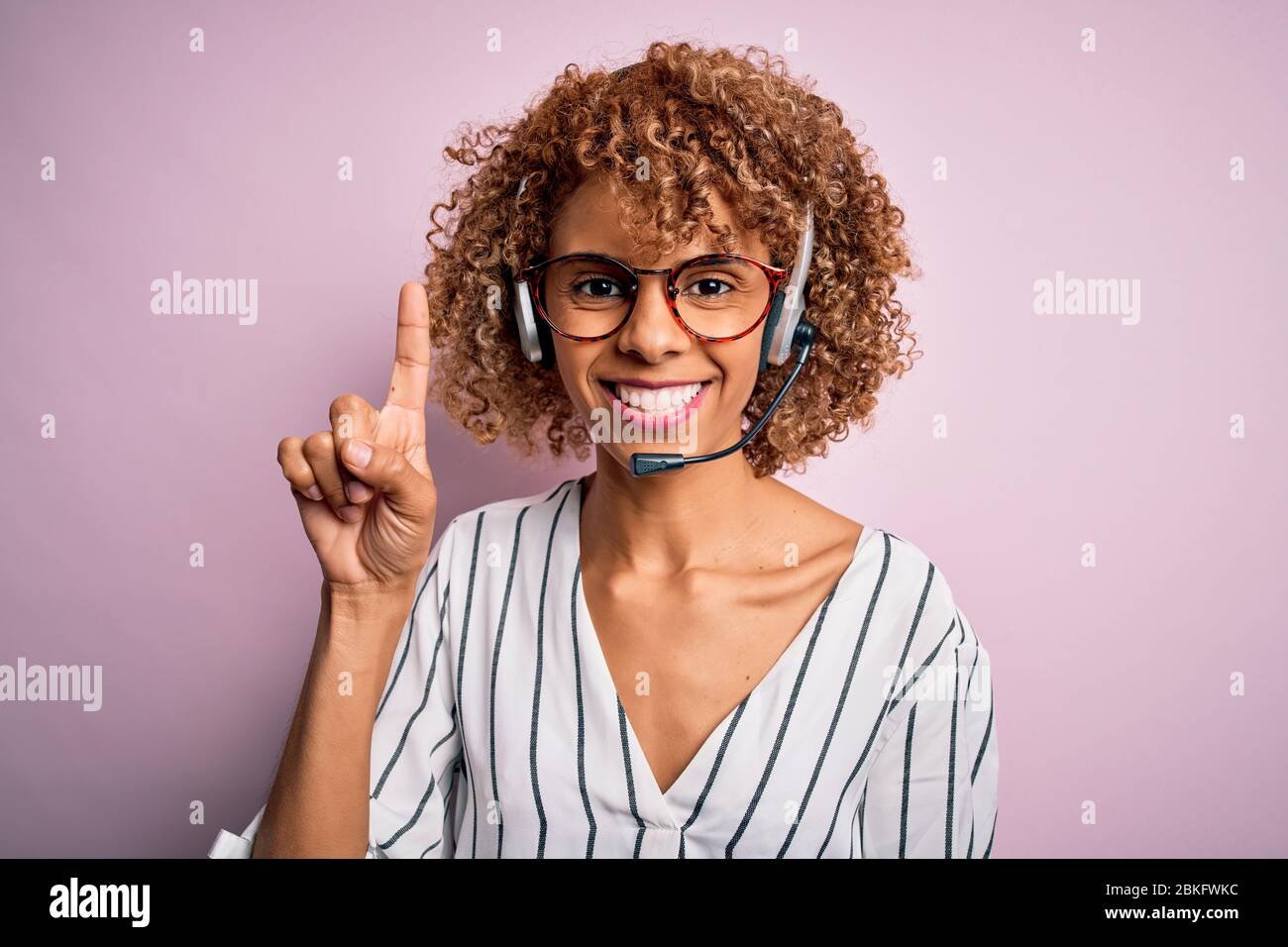 African american curly call center agent woman working using headset ...