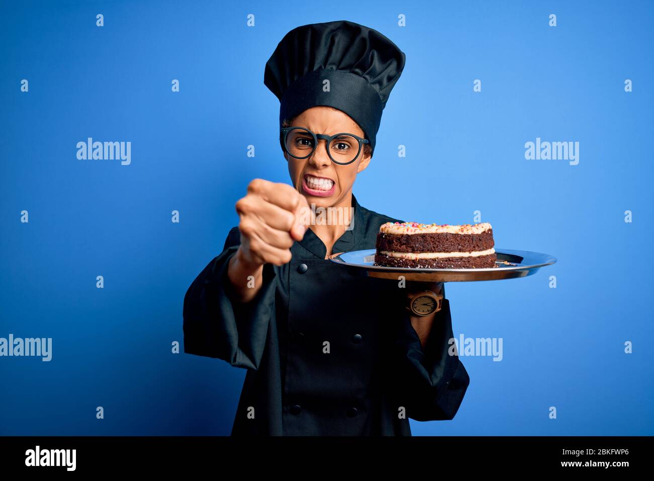 Young african american baker woman wearing cooker uniform and hat ...