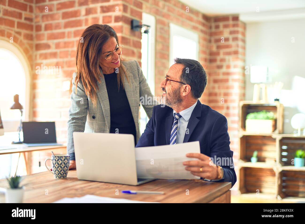Two middle age business workers smiling happy and confident. Working ...