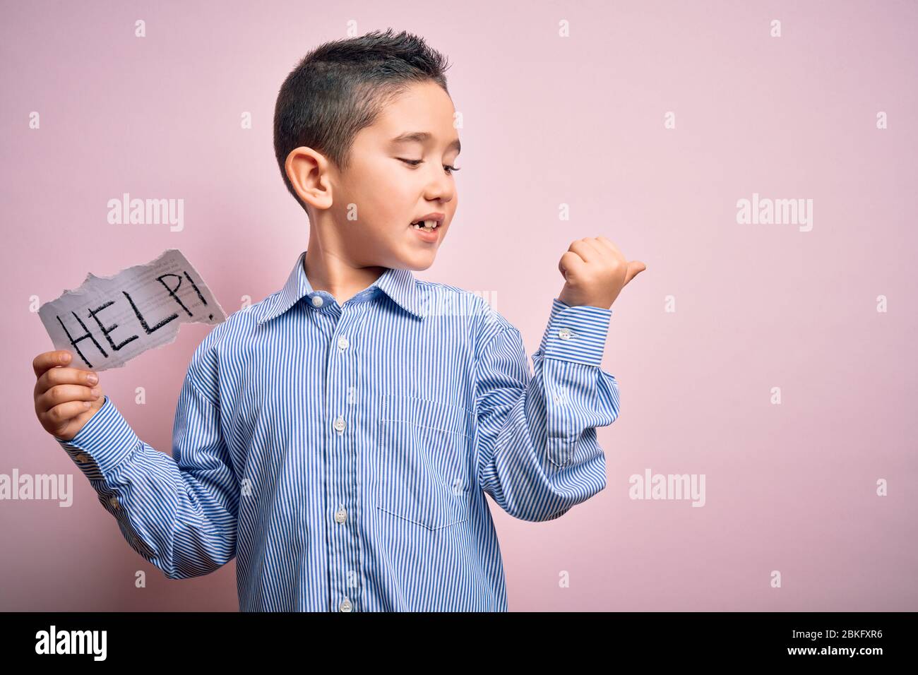Young little boy kid holding paper sing with help message asking for ...
