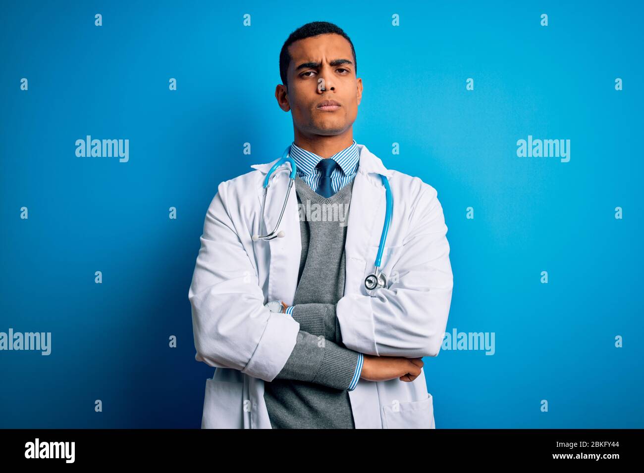 Handsome african american doctor man wearing coat and stethoscope over ...